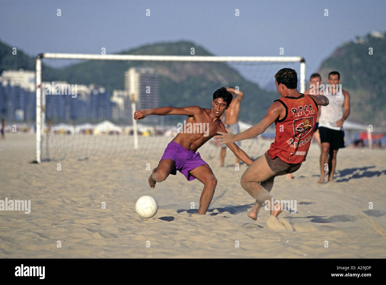 Men playing football on the sand at Copacabana Beach in Rio de Janeiro ...