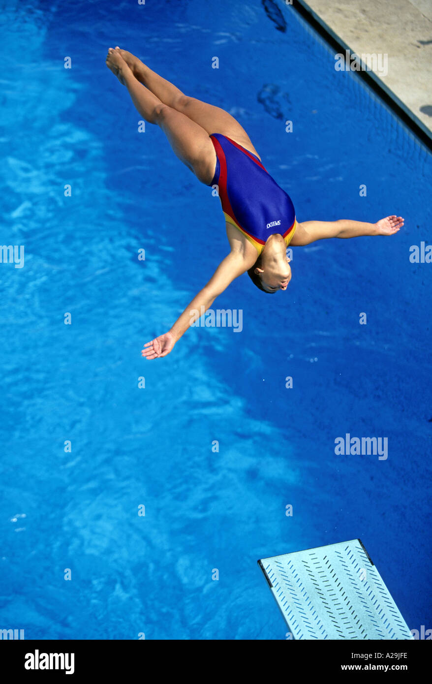Overhead view of a female diver forming a crucifix shape during a dive ...