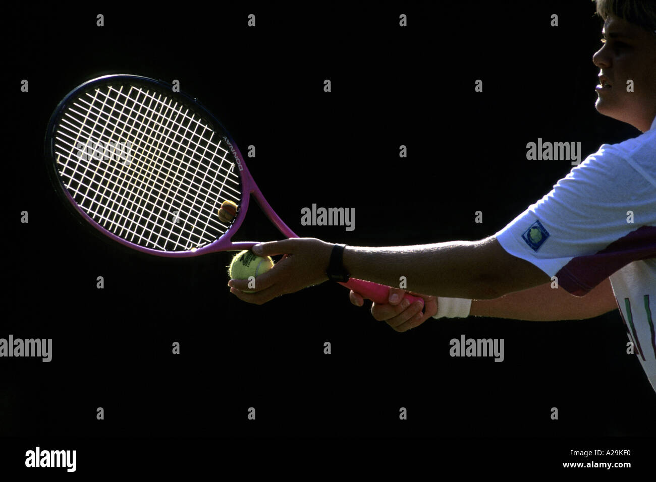 Close up of a male tennis player preparing to serve Side on view of the ...