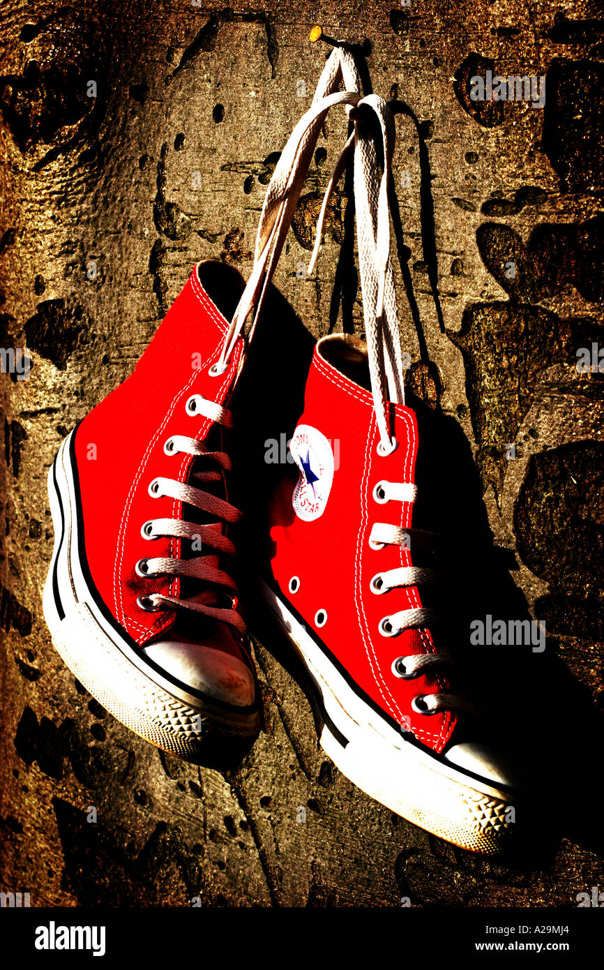 Red boots hanging on a tree Stock Photo - Alamy