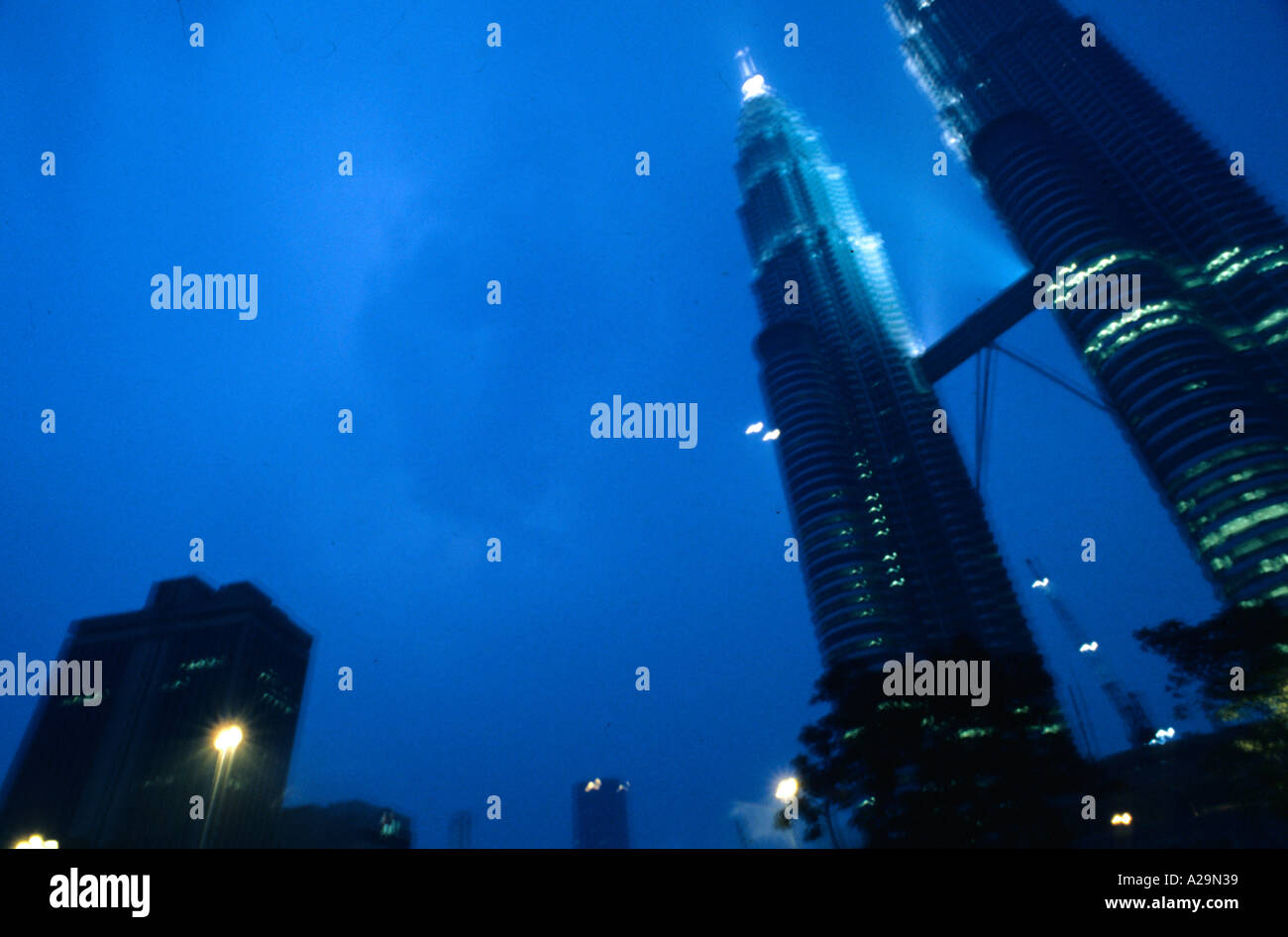 Petronas Towers glistening in the mid summer rain in Kuala Lumpur ...