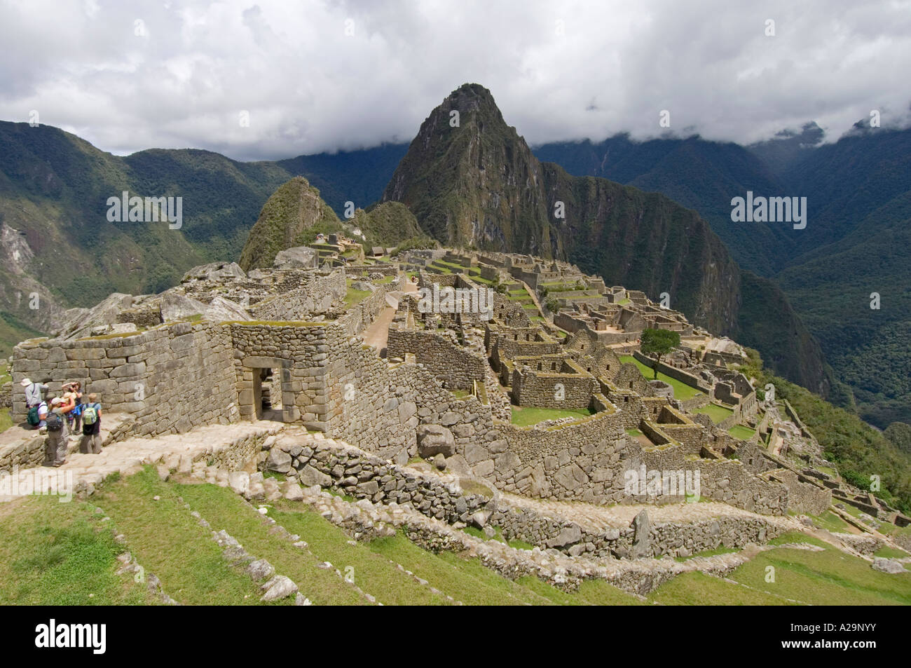 A group of tourists at the ancient Inca site of Machu Picchu in Peru ...
