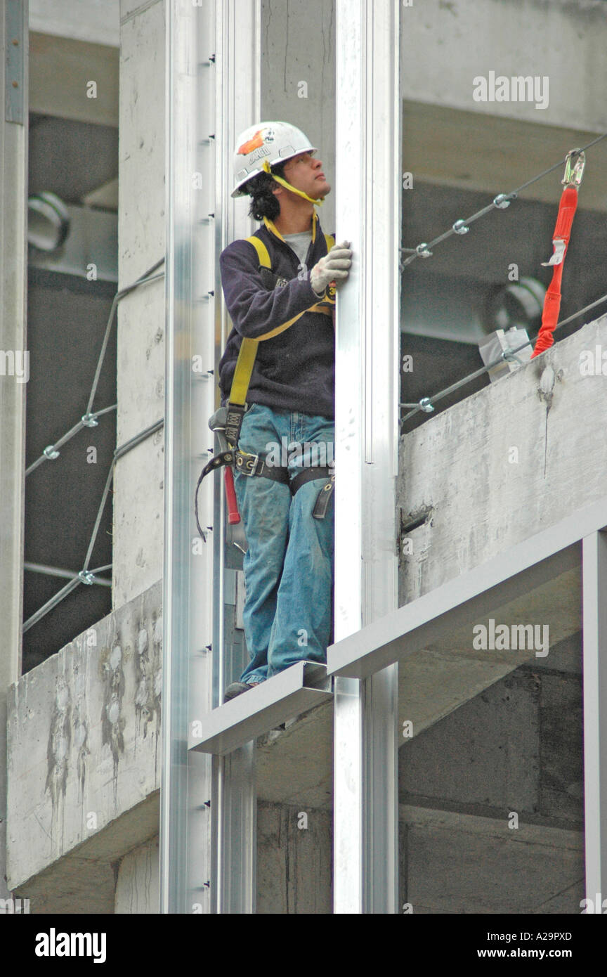 High rise construction of iron and steel beams and cement with workers ...