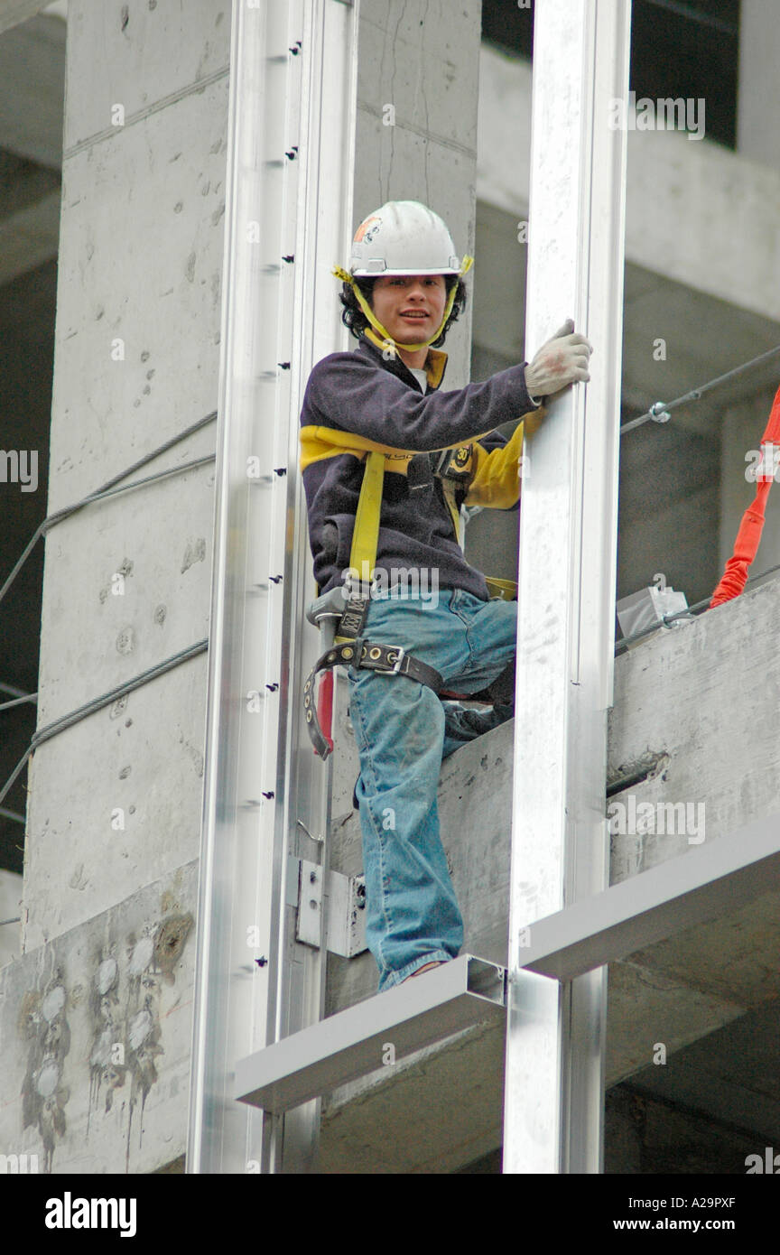 High rise construction of iron and steel beams and cement with workers ...