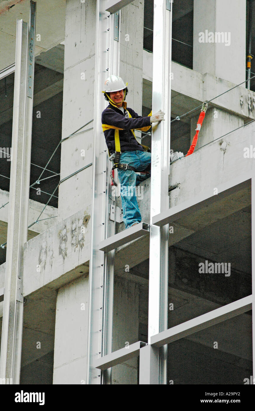 High rise construction of iron and steel beams and cement with workers ...