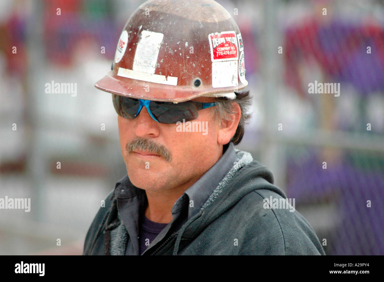 Man with glasses who is a High rise construction worker of iron and ...