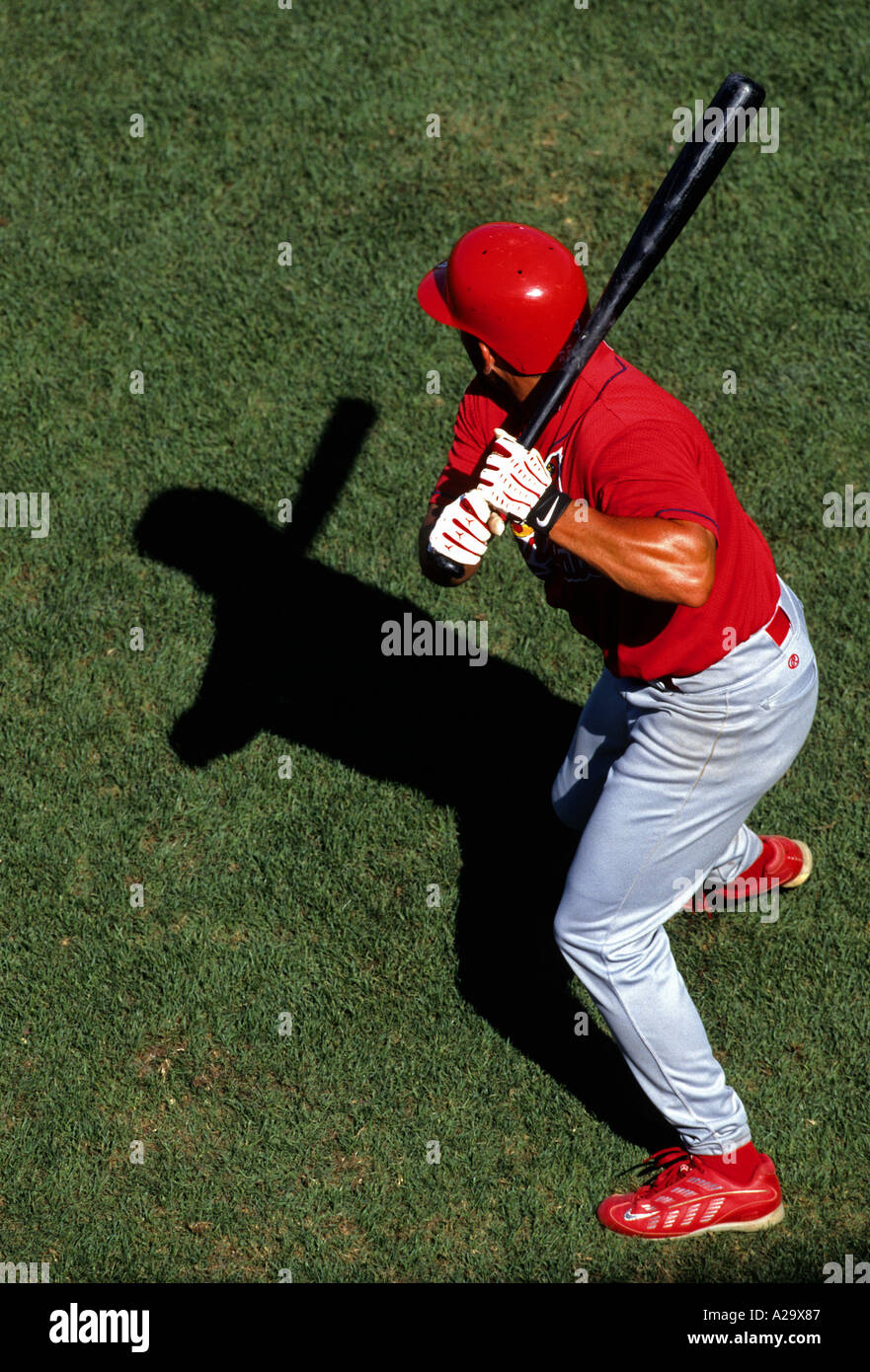 Overhead view of baseball hitter in a red shirt preparing to swing his ...