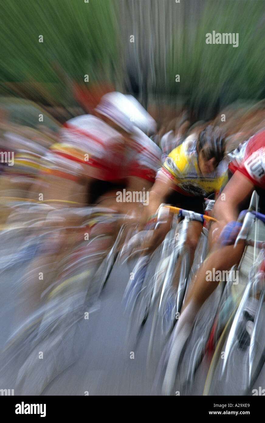 The blur of a group of racing cyclists cornering during a cycling road ...