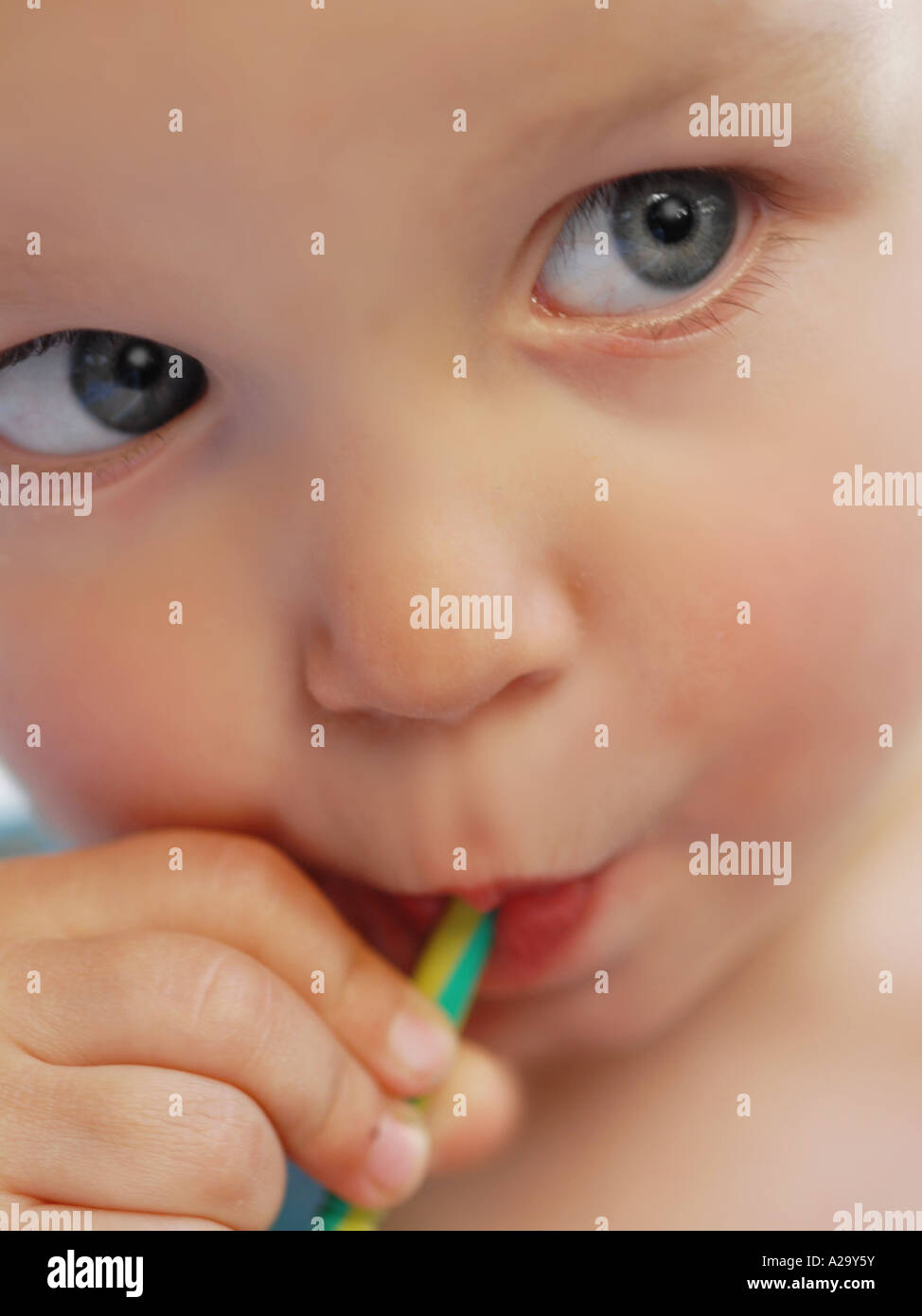 Girl drinking with a straw Stock Photo - Alamy