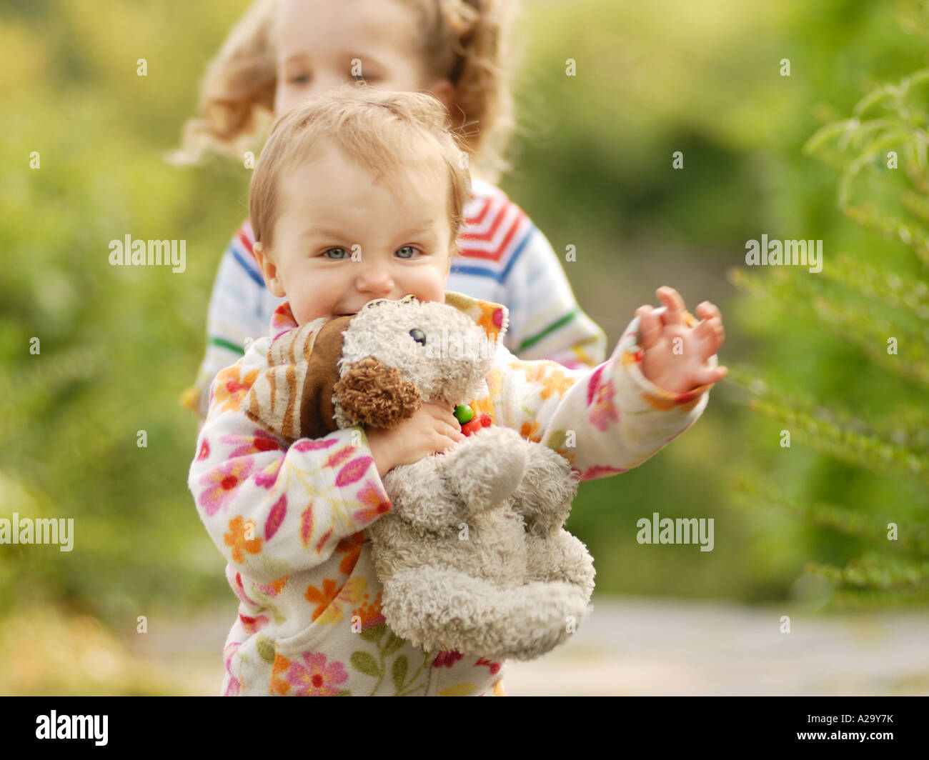 two kids chase each other and having fun Stock Photo - Alamy