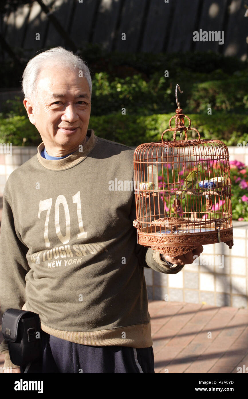 Man with his pet bird, Hong Kong Stock Photo - Alamy