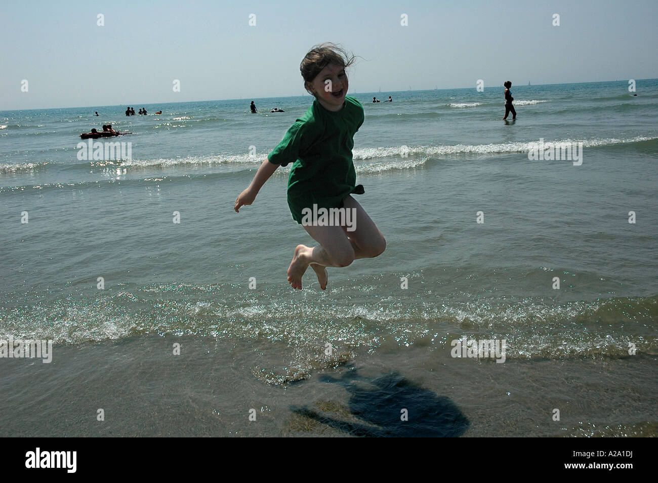 Girl jumping sea england hi-res stock photography and images - Alamy