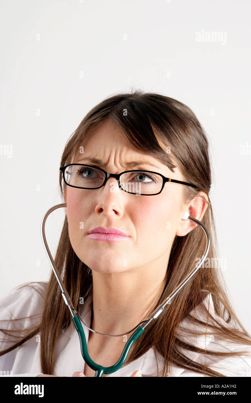 Young female doctor A1 A 1 listening intently through a stethoscope ...