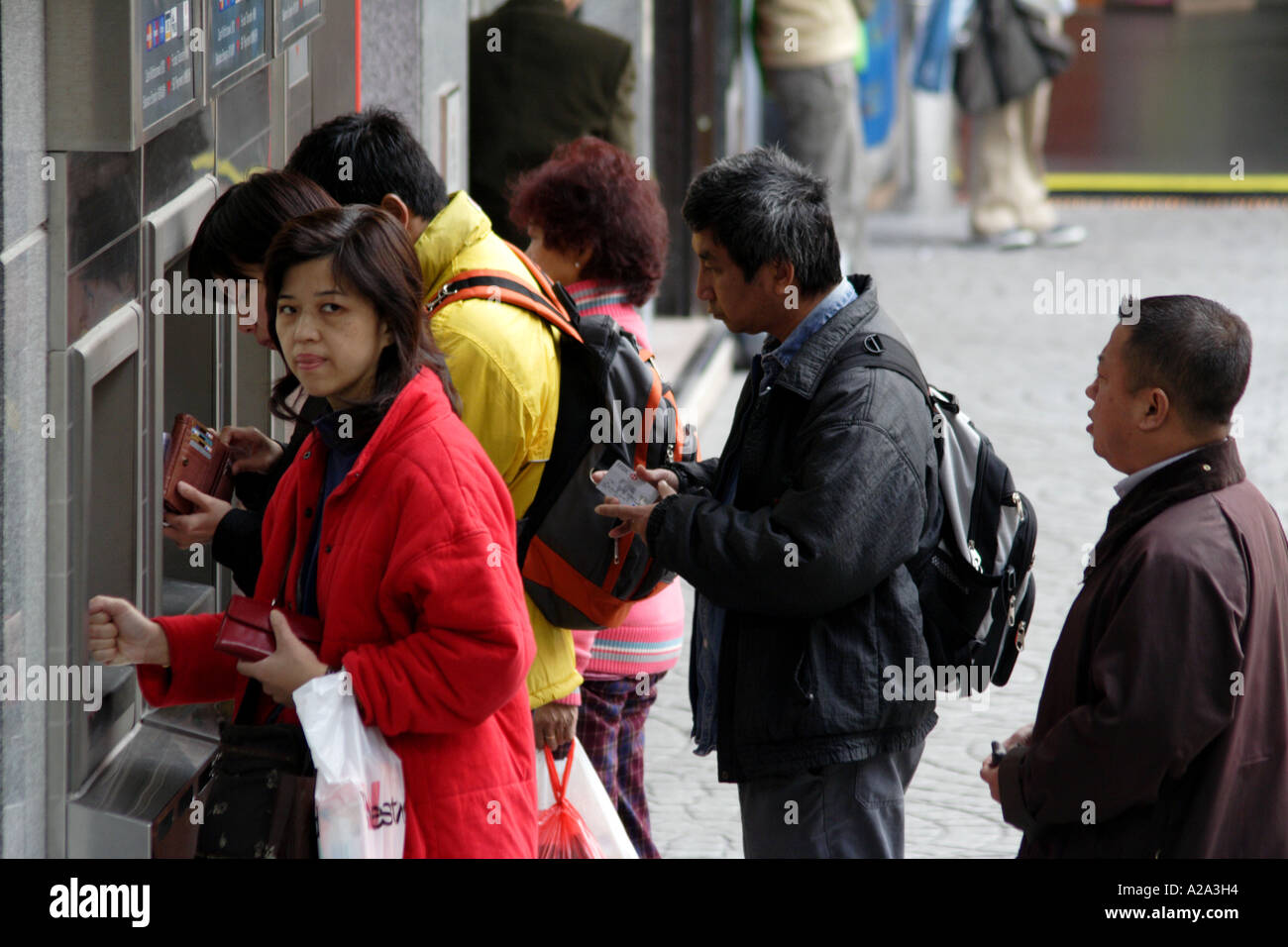 Lined up at a bank ATM, Hong Kong SAR Stock Photo - Alamy