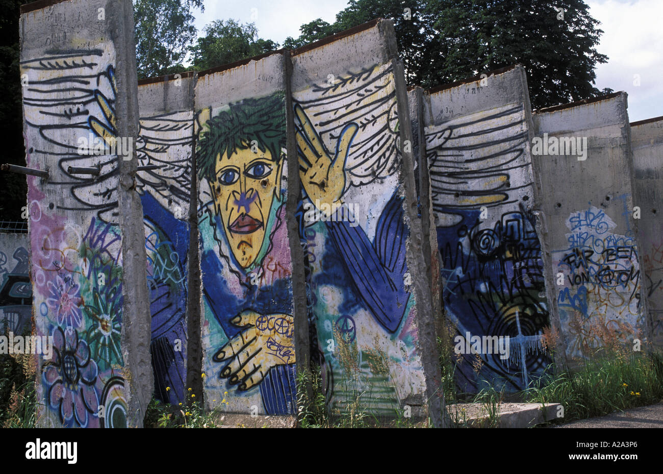 Germany Berlin a painting of an angel covers old sections of the Berlin ...