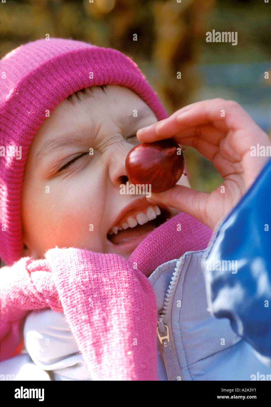 Boy putting onion nose Stock Photo - Alamy