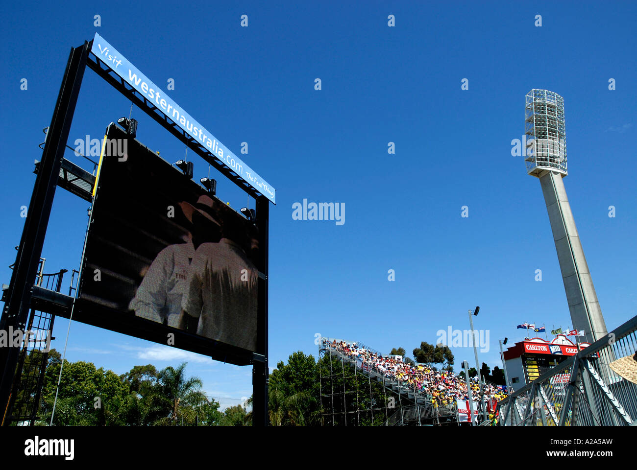 huge outdoor screen showing cricket action, with light pylon in ...