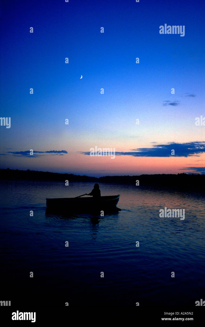 A sunset journey in a rowing boat Stock Photo - Alamy