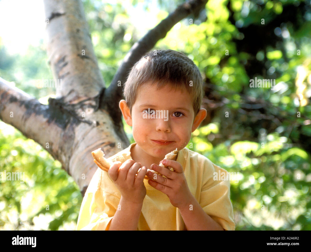 Boy eating bread Stock Photo - Alamy