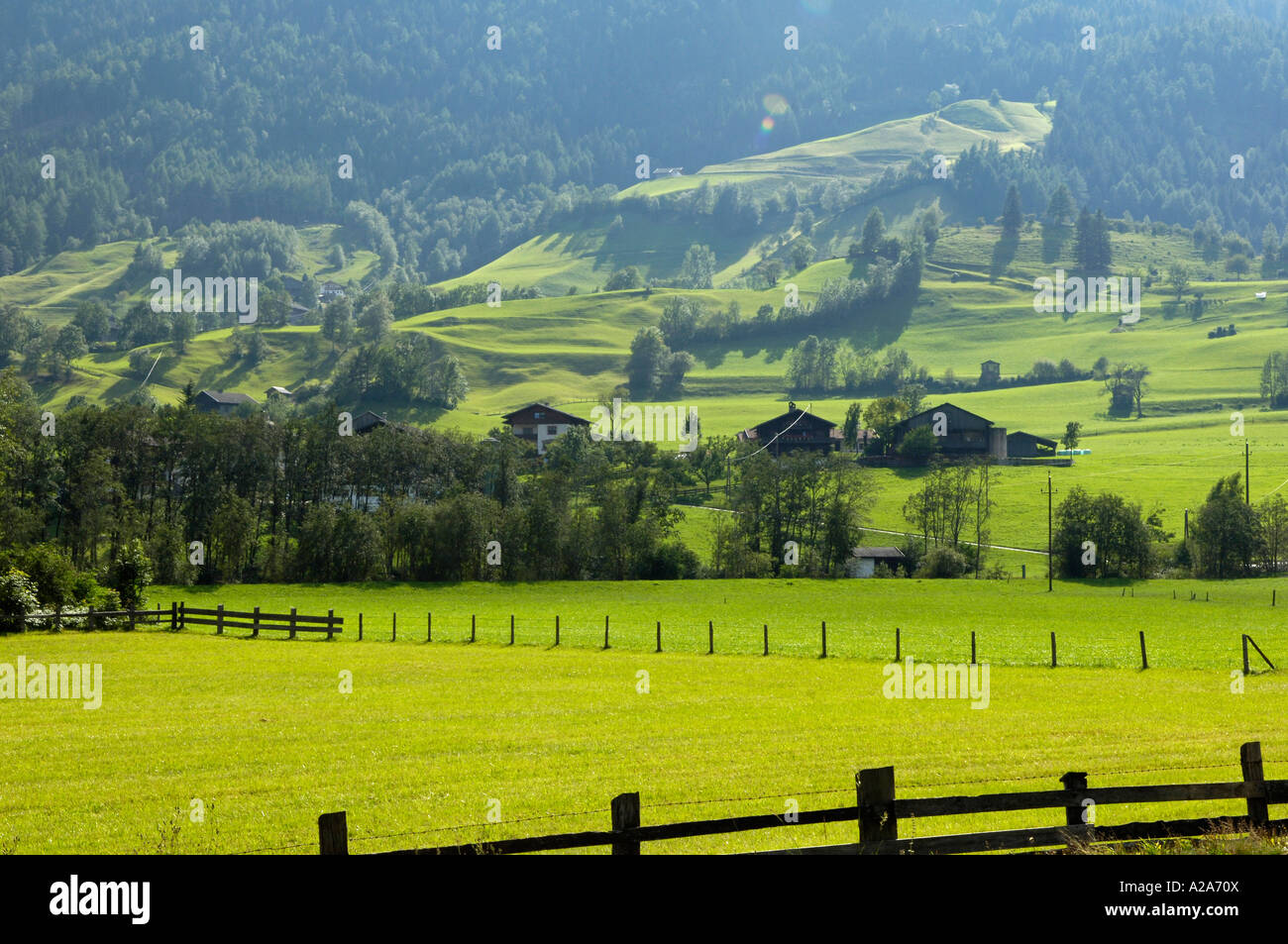 several farm houses in a hilly landscape, wide fields Stock Photo - Alamy