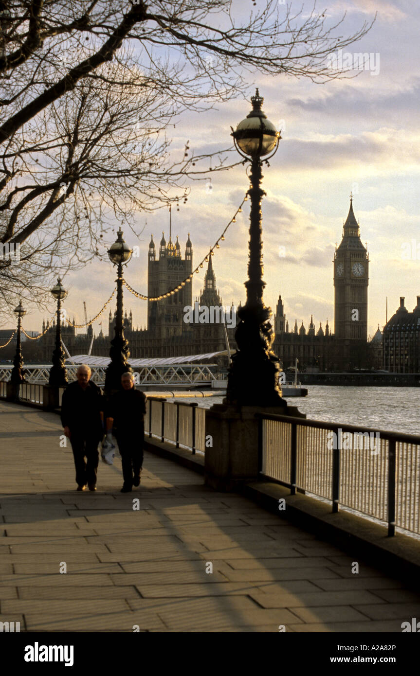 People walking along the River Thames with the 19th century Houses of ...