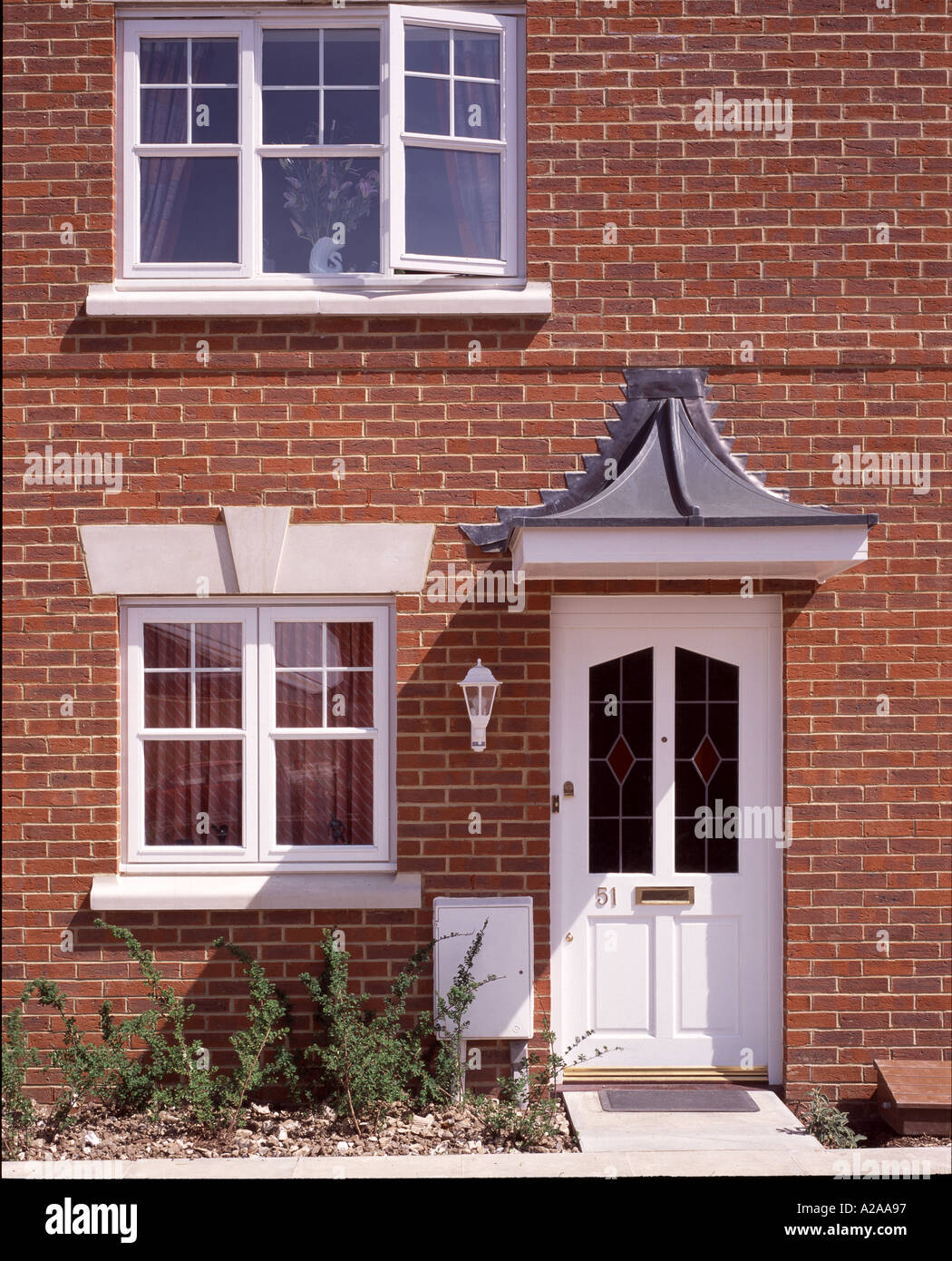 New brick house with white front door and canopy Stock Photo - Alamy