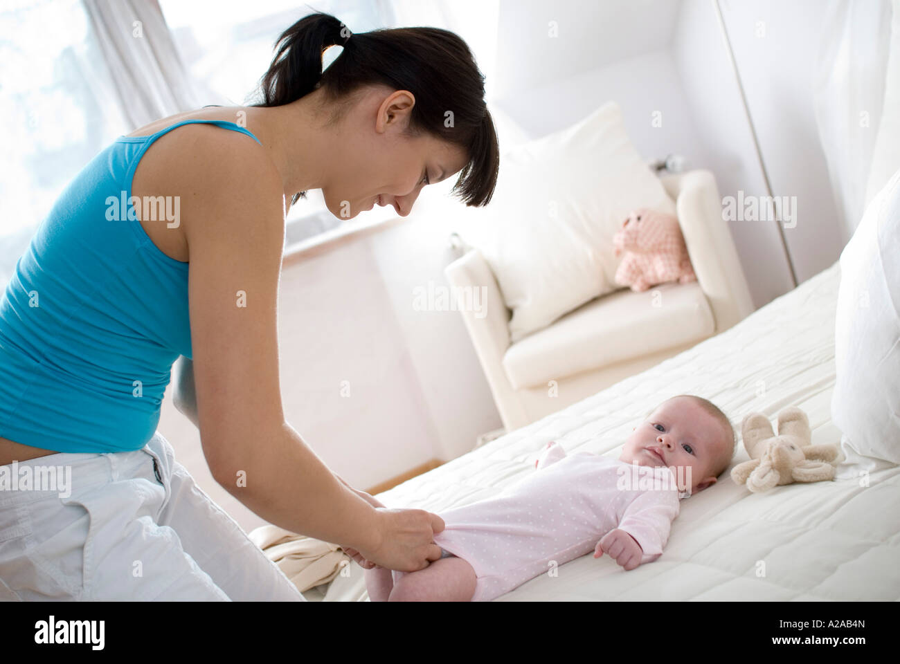 mum dressing baby Stock Photo - Alamy