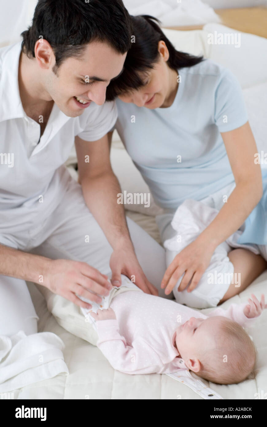 parents changing their baby's diaper Stock Photo - Alamy