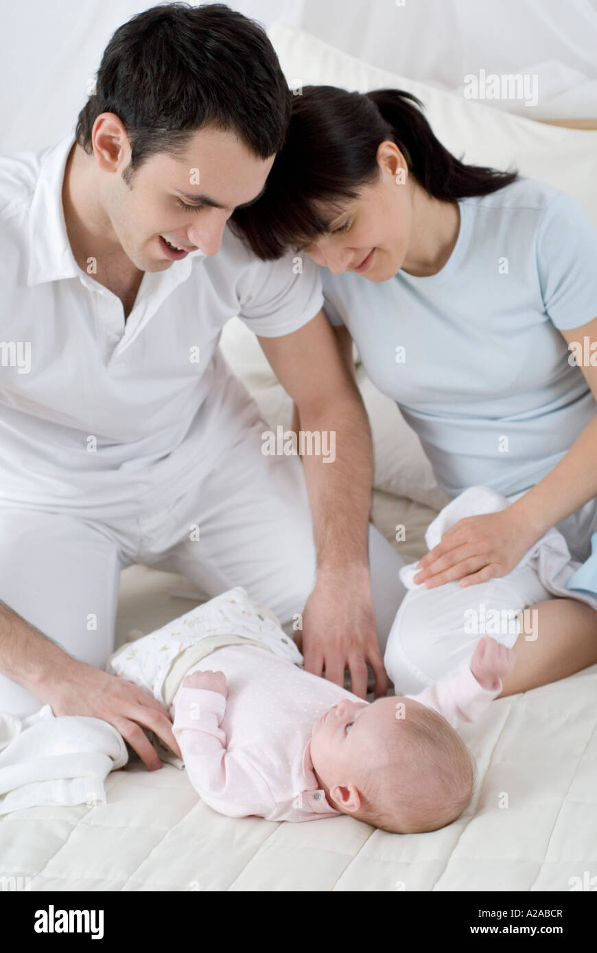 parents changing their baby's diaper Stock Photo - Alamy