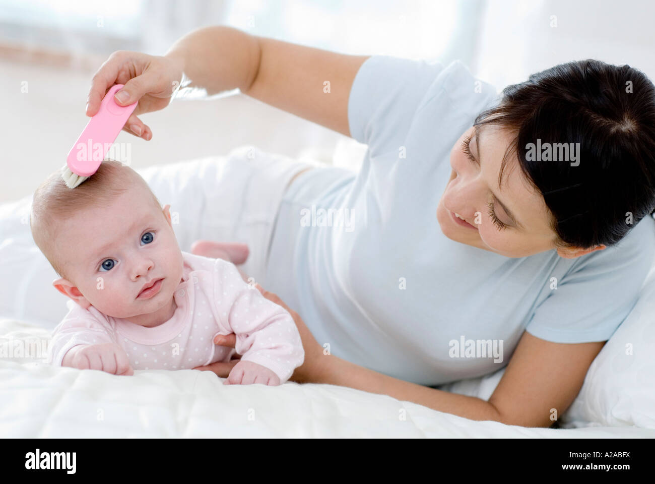 mother combing her baby's hair Stock Photo - Alamy