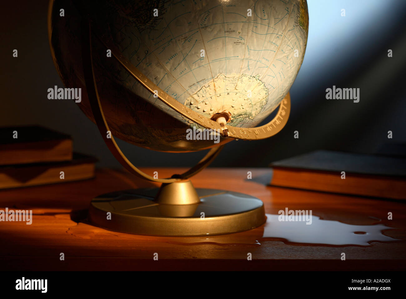 Earth Globe dripping water on school desk Stock Photo - Alamy