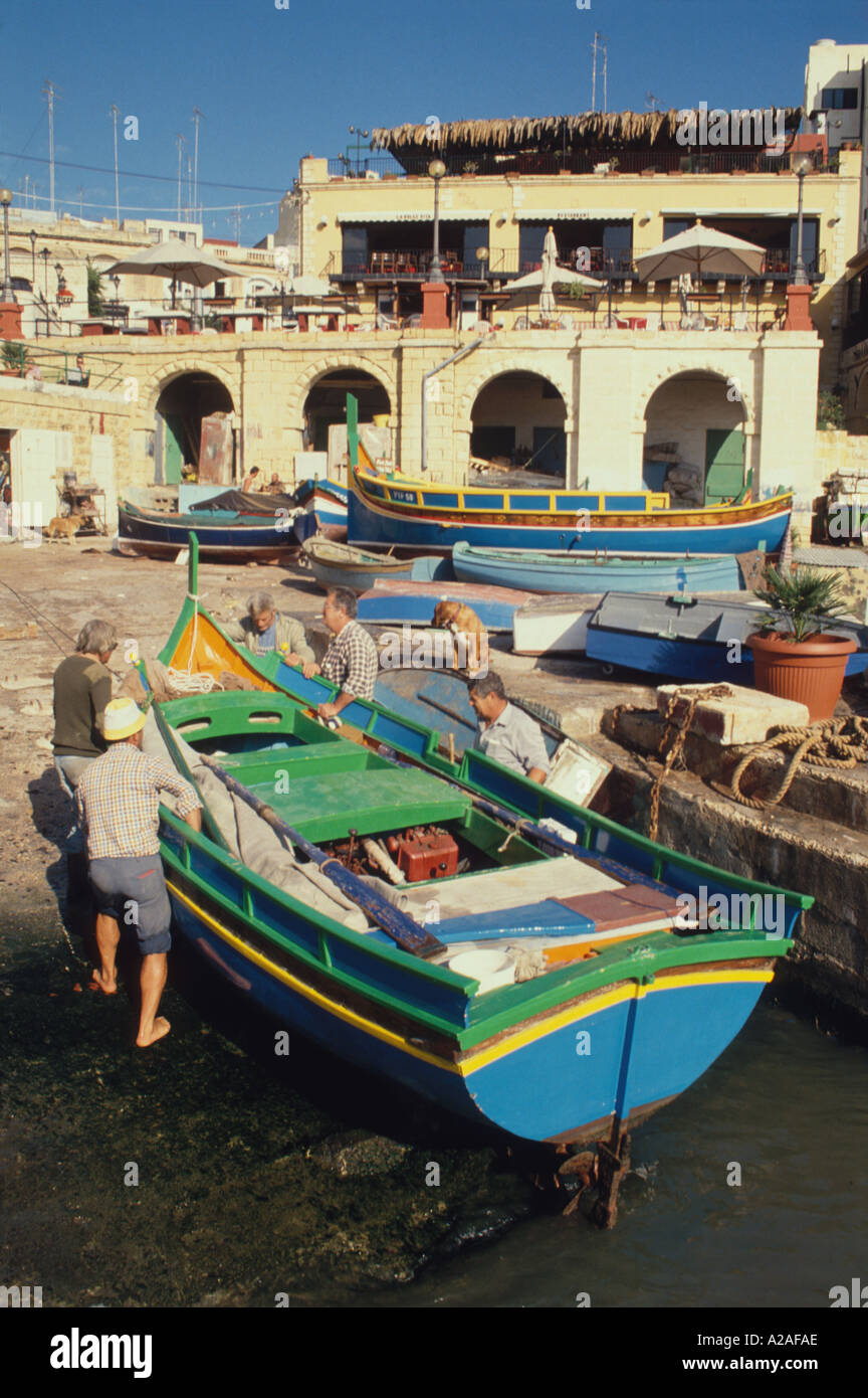 Hauling out a kajjik class inshore fishing boat at St Julians Bay Malta ...