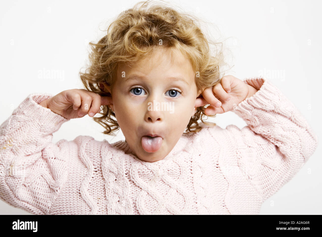Child young girl 3 4 5 years making silly face Stock Photo - Alamy