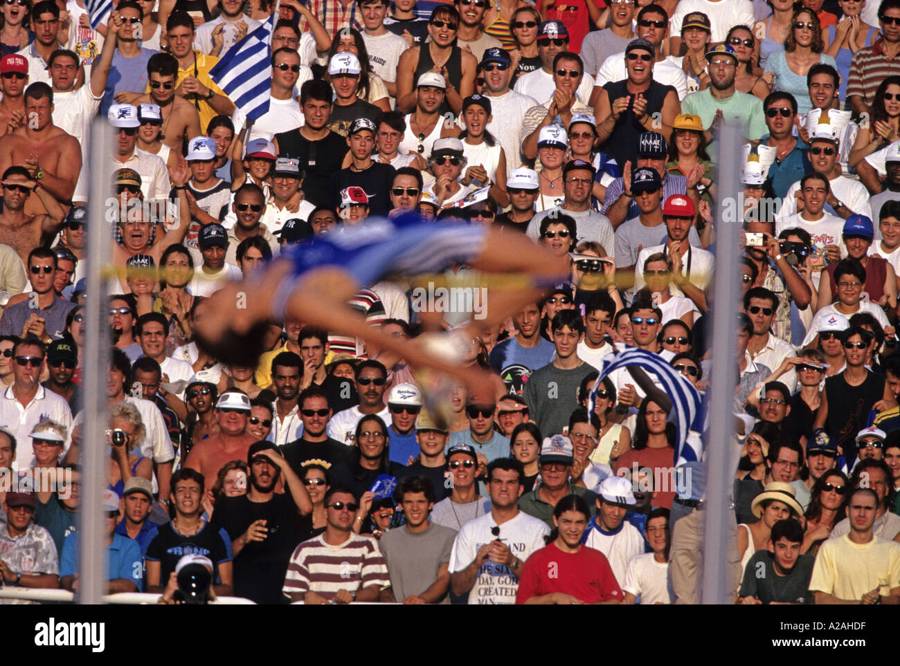 Faces in the crowd concentrate on a jumper in the high jump competition ...