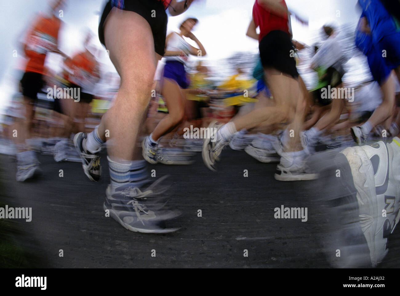 The blur of a crowd of runner s legs distorted by a wide angled lens ...