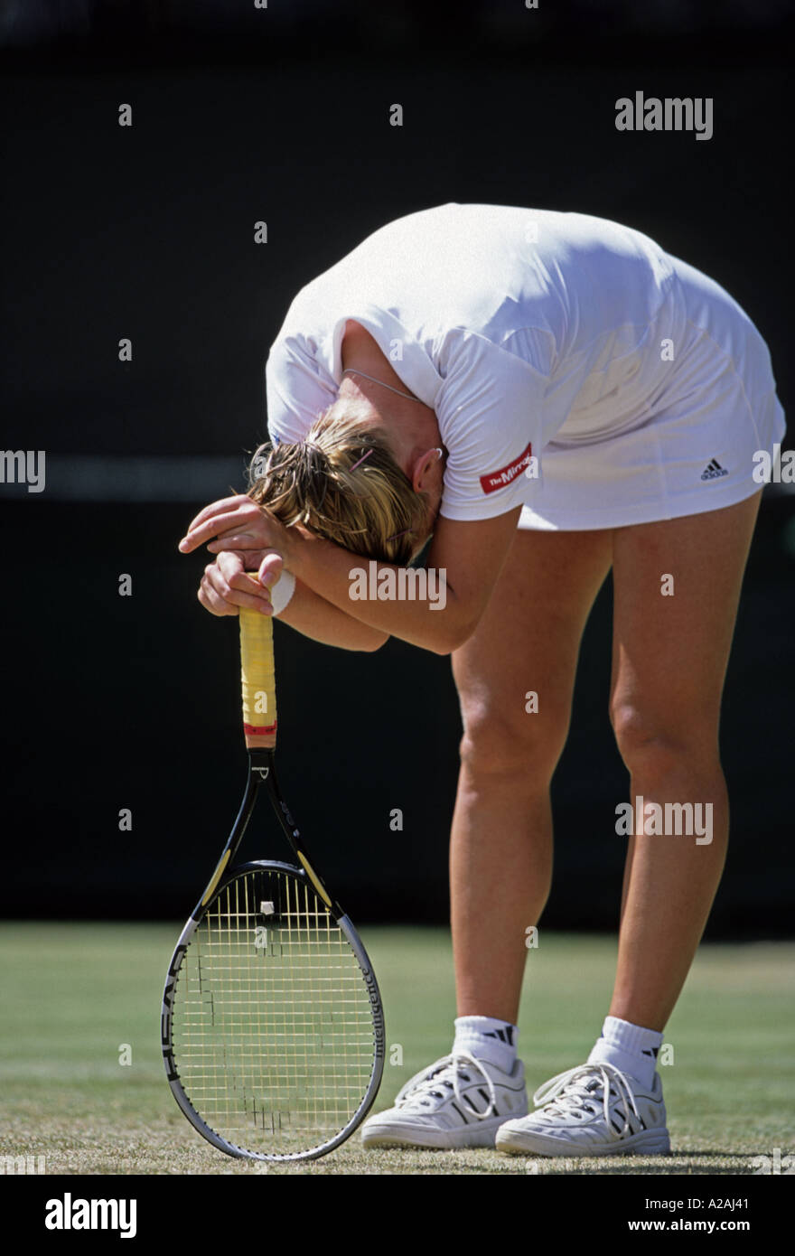 Exhausted female tennis player hangs her head in disappointment during ...