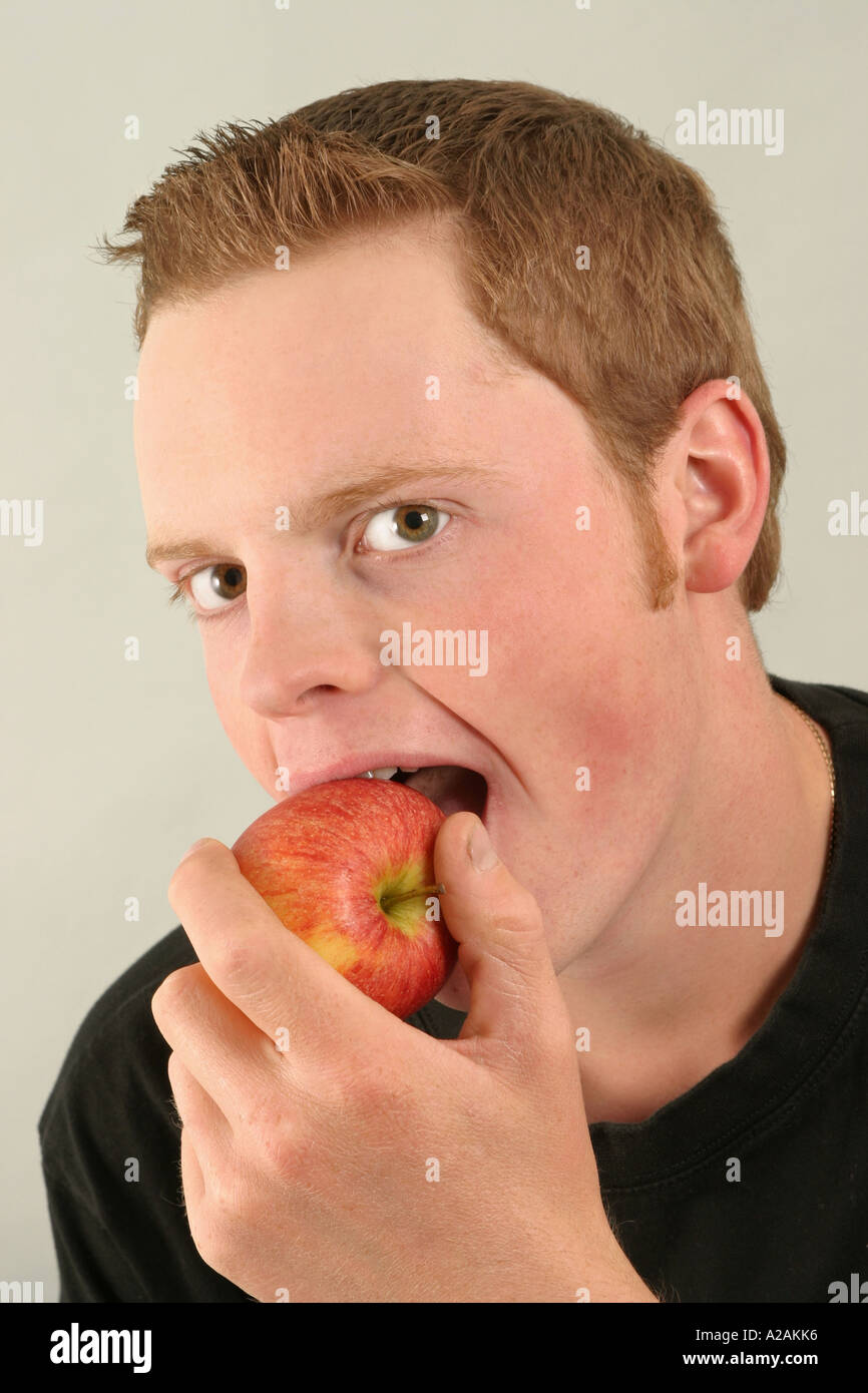 Black teenager eating apple hi-res stock photography and images - Alamy