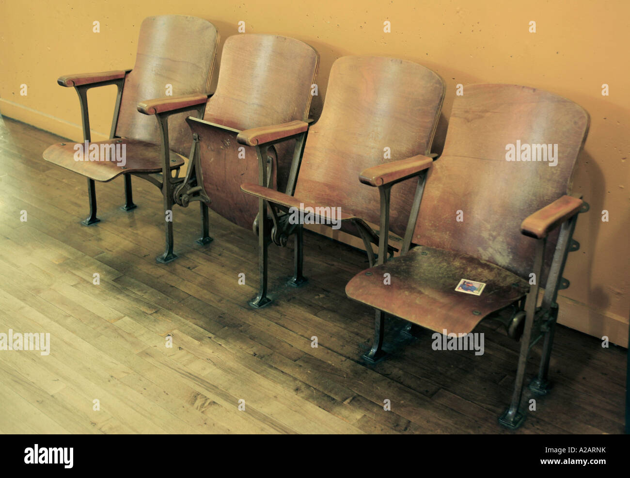 four fold down chairs in timber floored hallway Stock Photo - Alamy