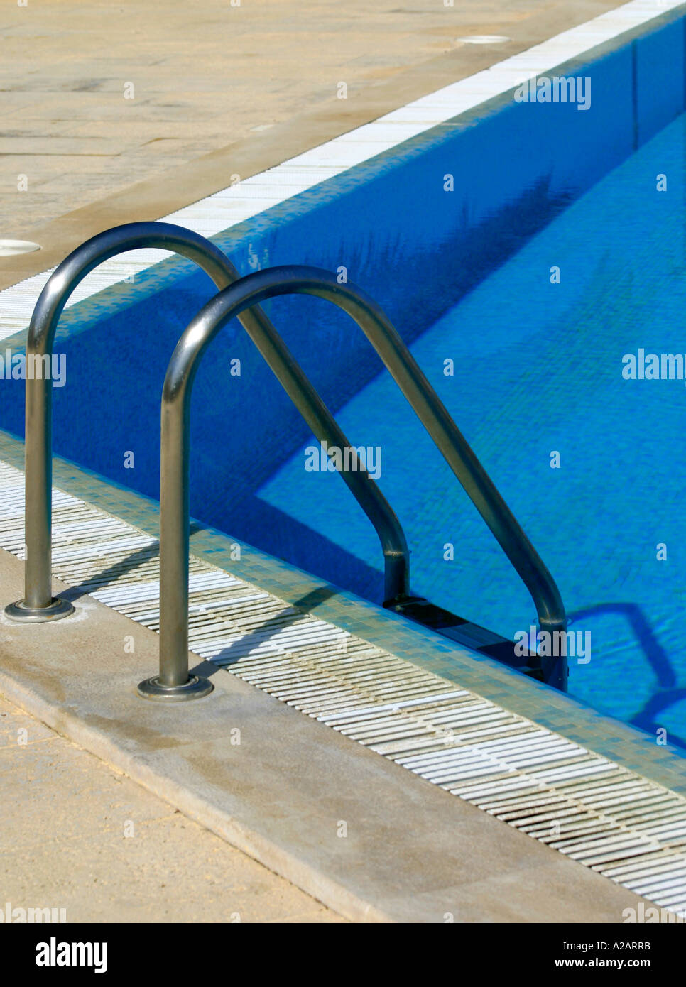 Swimming pool with blue water in summer sunshine Stock Photo - Alamy