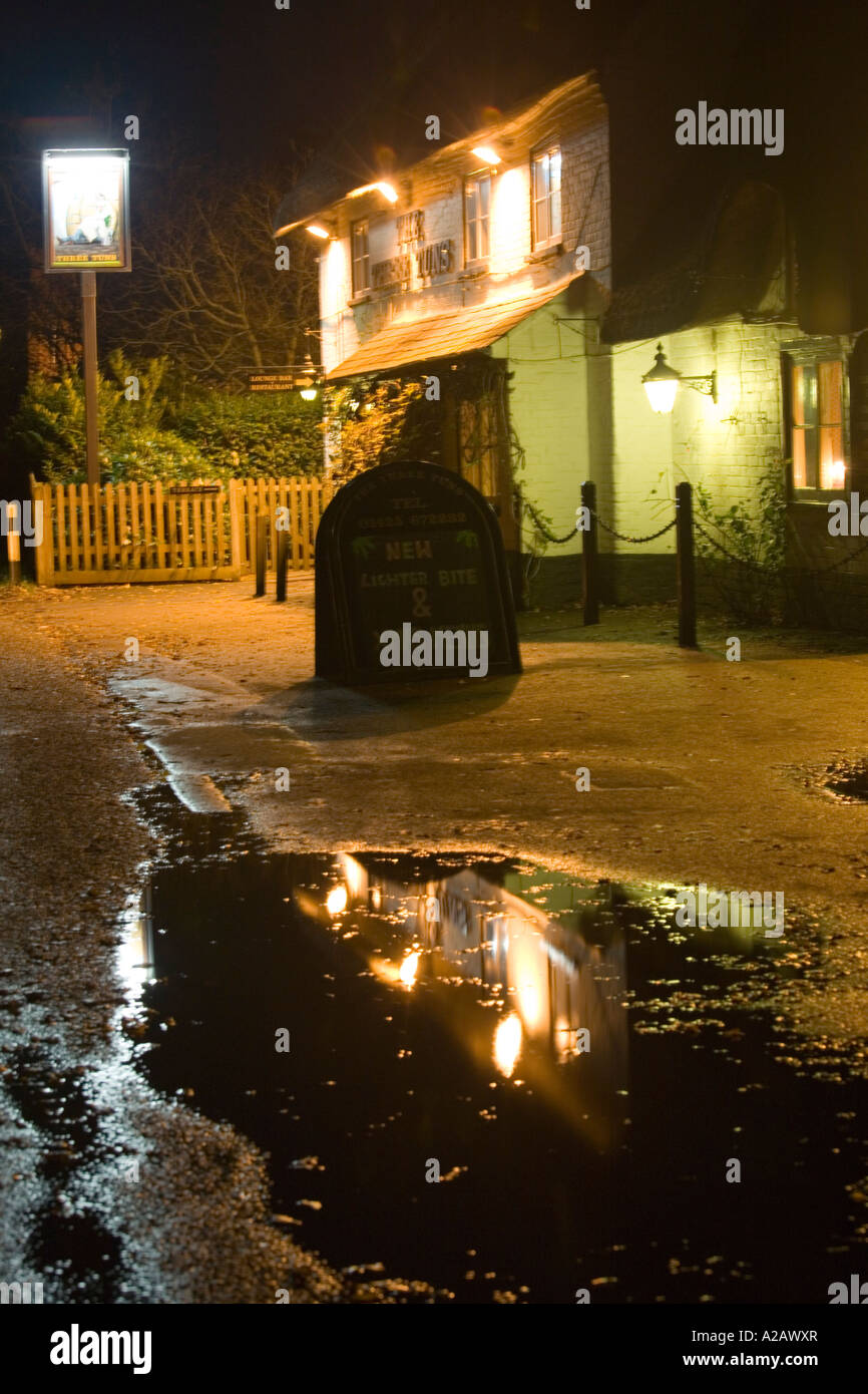 The lights of a pub at night reflected in a puddle Stock Photo - Alamy