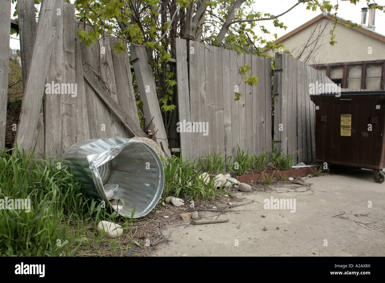 damaged trash can in driveway Stock Photo - Alamy