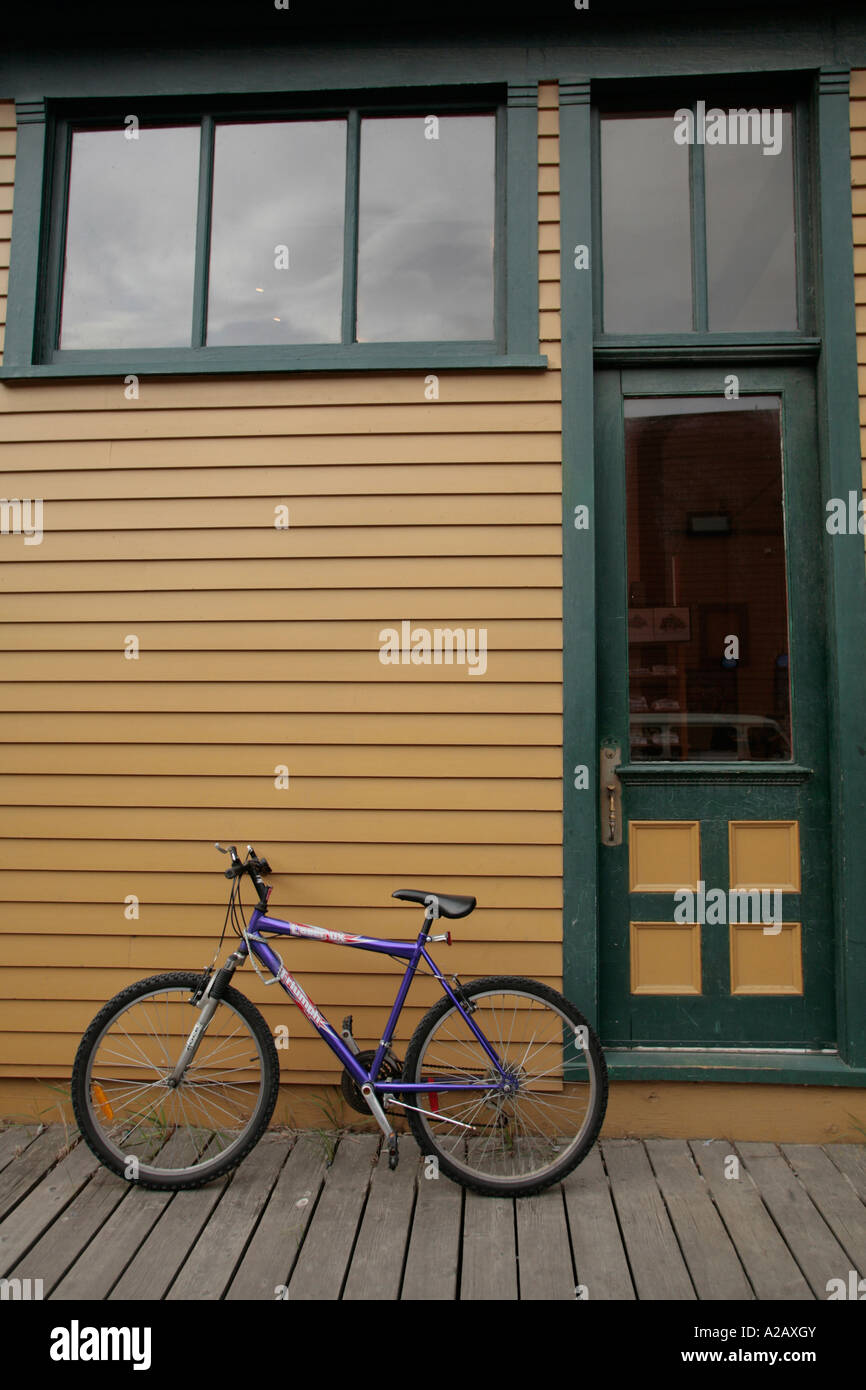 Bicycle parked outside timber framed dwelling house Stock Photo - Alamy