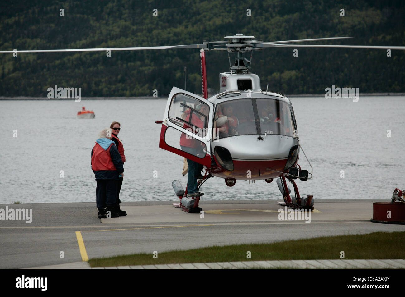 passengers boarding helicopter at airfield Stock Photo - Alamy