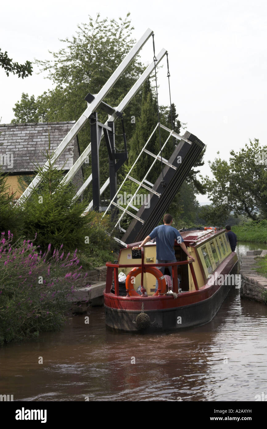 Canal boat passing under lifting bridge on brecon canal Stock Photo - Alamy