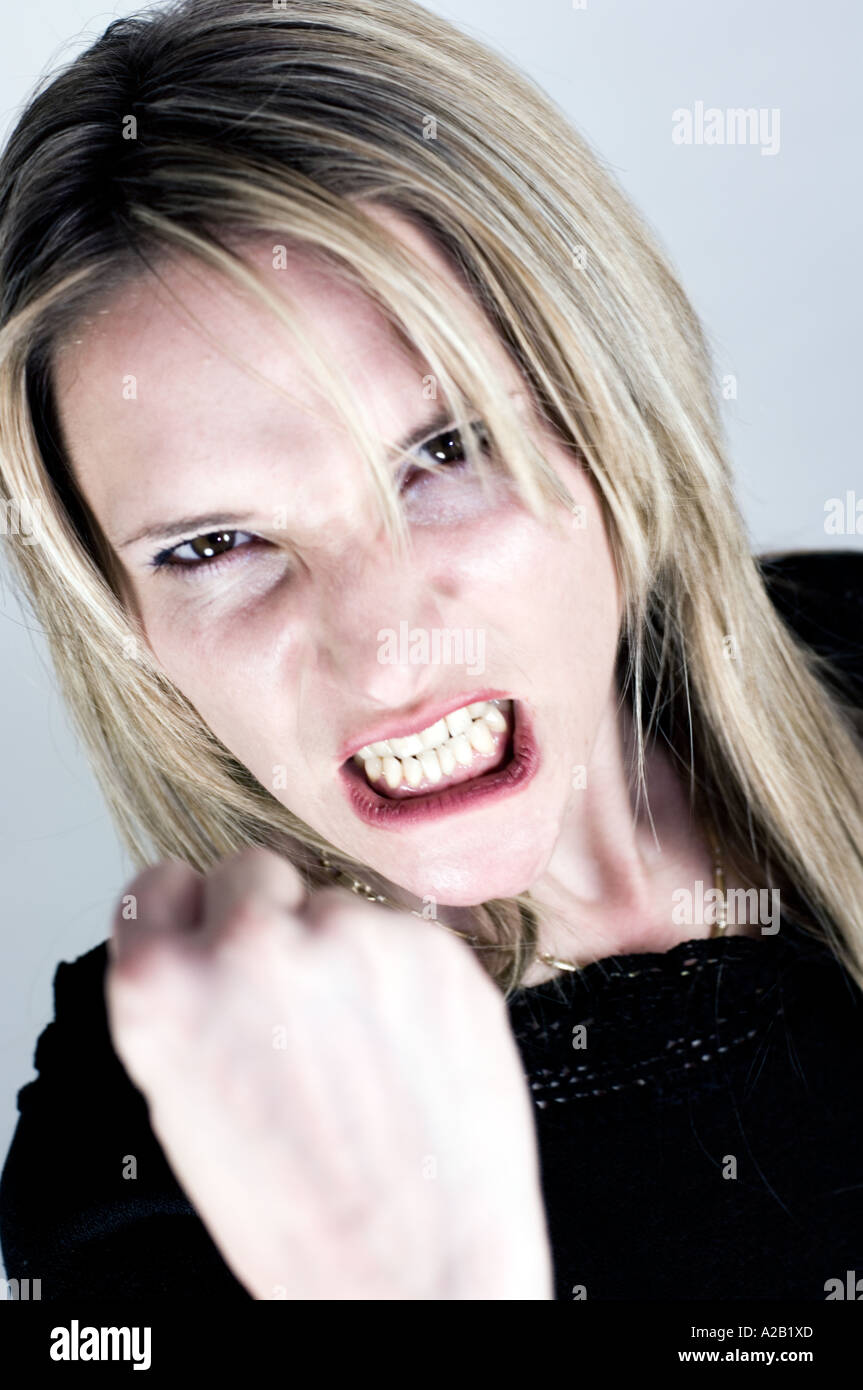 An angry woman with her fist clenched Stock Photo - Alamy