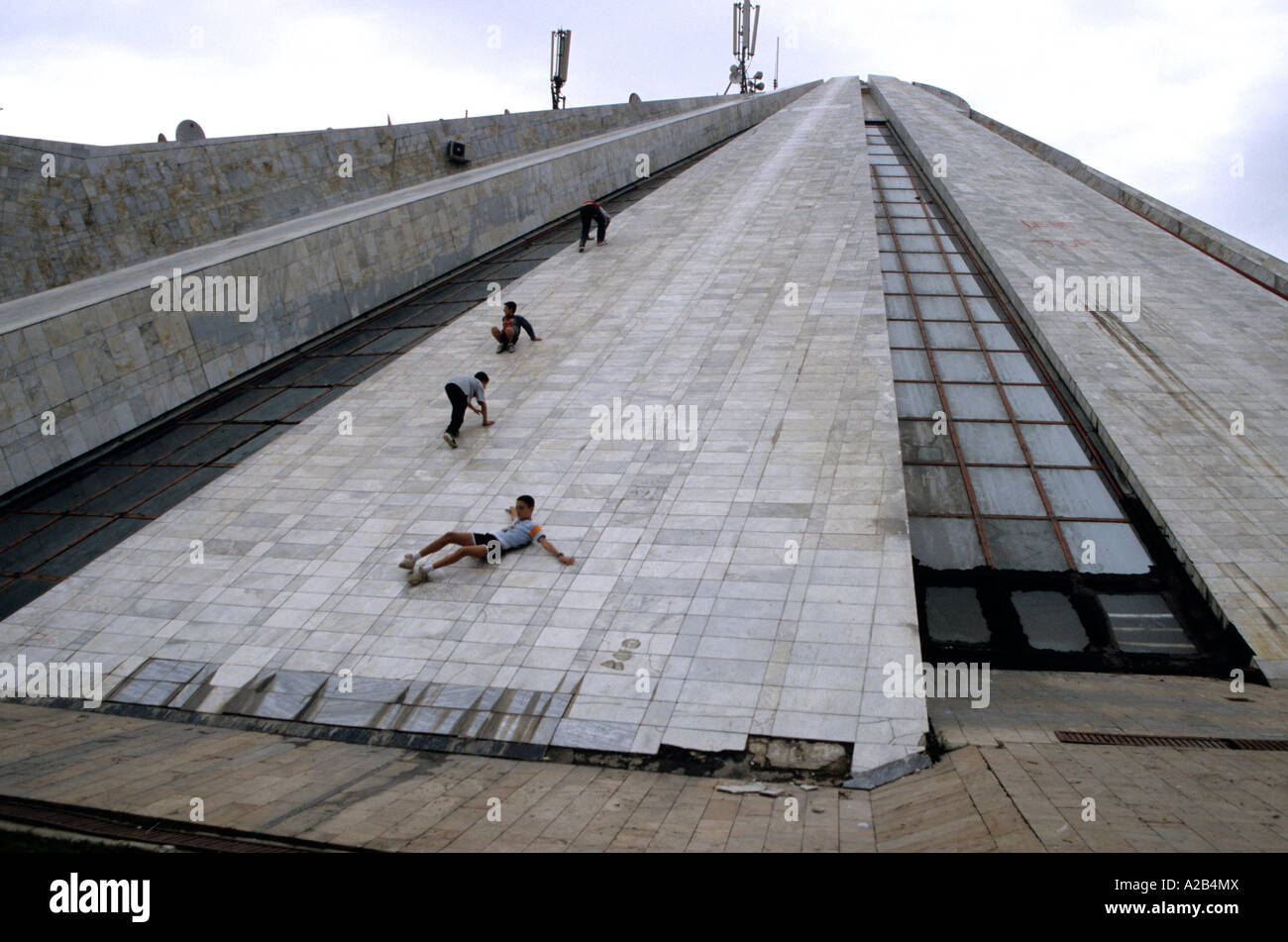 Boys sliding down the former mausoleum of Enver Hoxha Albanian dictator ...