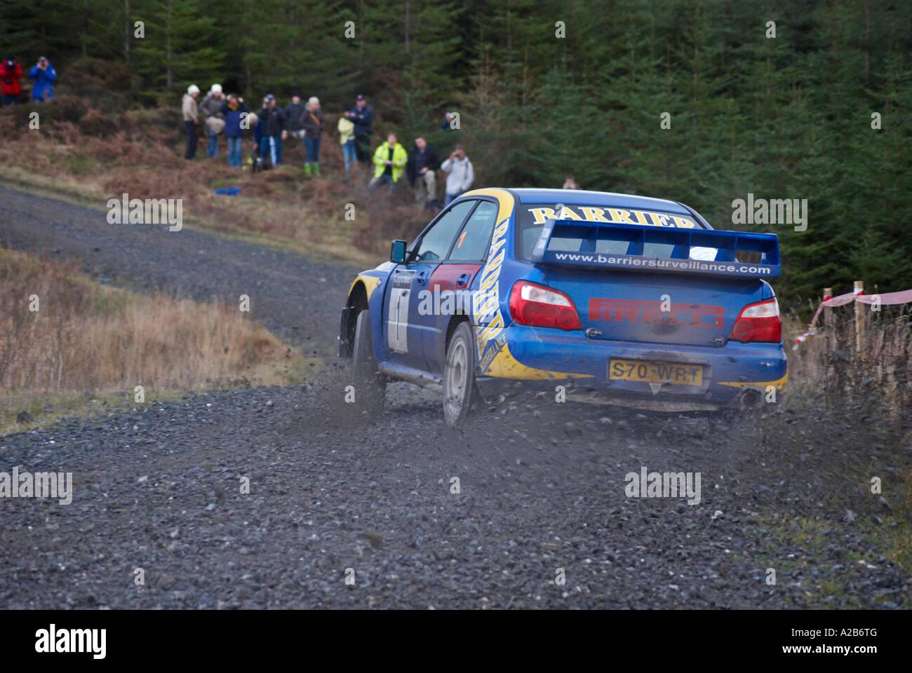 Rally Car Rear view of a competitors car that is sliding around a bend ...