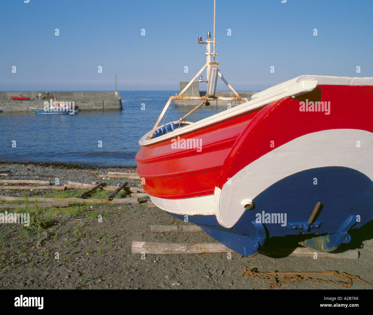 Traditional wooden Coble fishing boat and the harbour, Craster ...