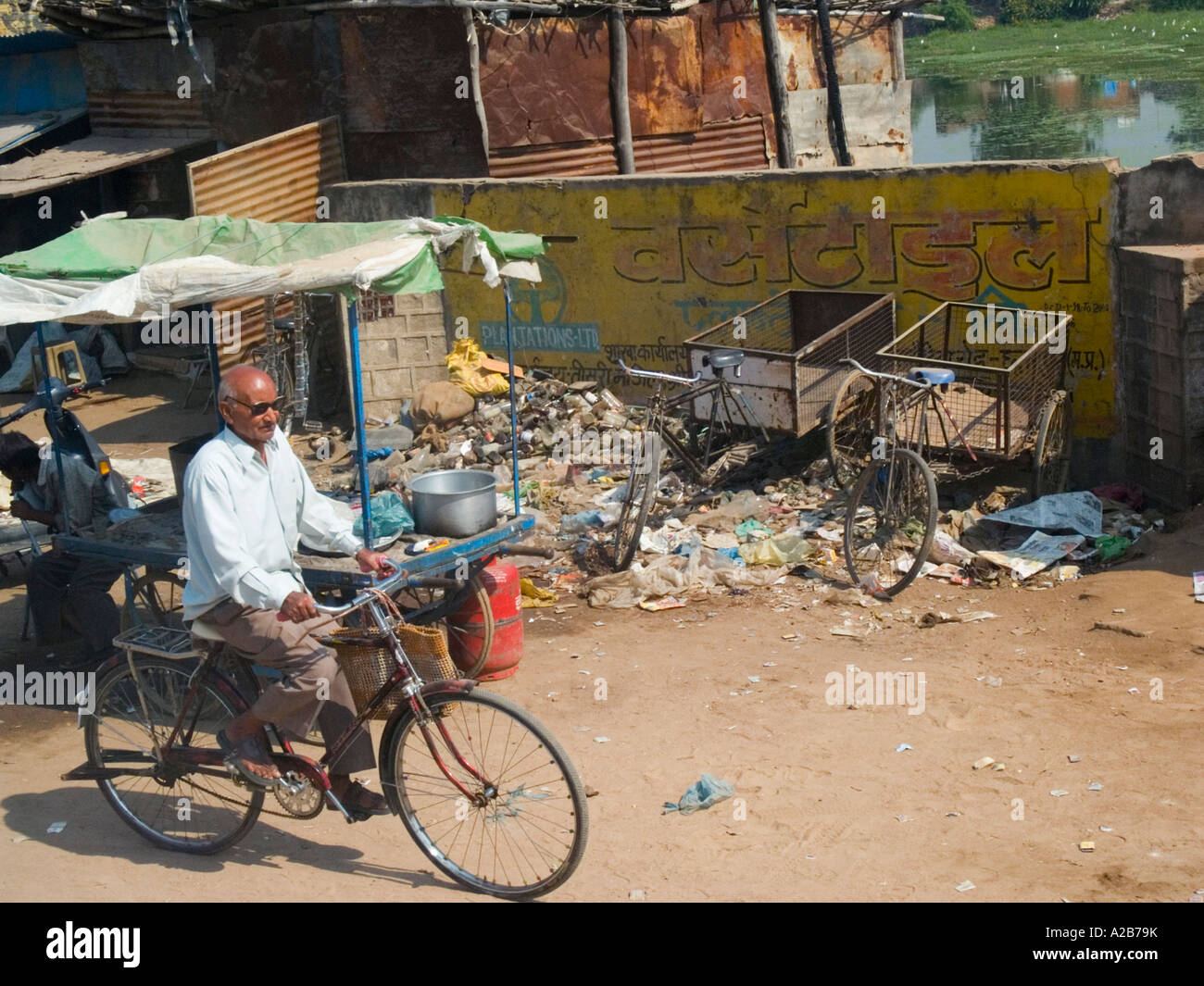 Typical dirty town street scene with pile of rubbish local man on ...
