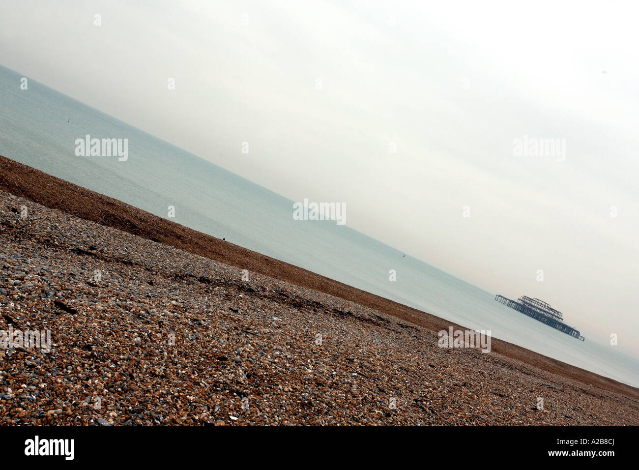 Pebble beach and ruins of West Pier Brighton UK Stock Photo - Alamy